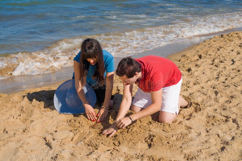 Digging on the beach stock photo. Image of happy, women - 41106932