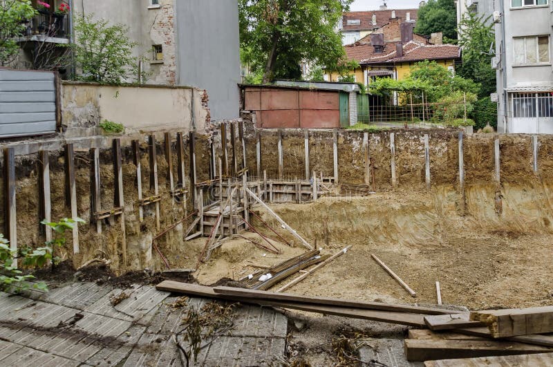 Digging the Pit Foundation a Hole with Excavator at the Construction ...