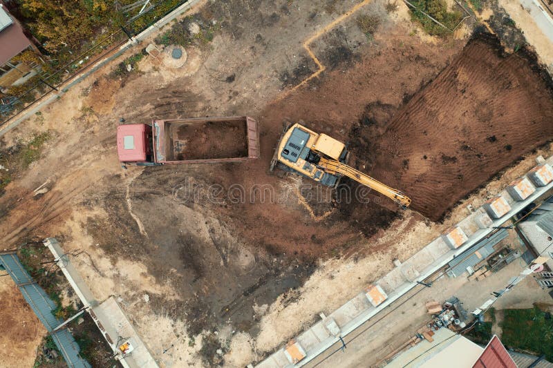 Digging the Pit Foundation a Hole with Excavator at the Construction ...