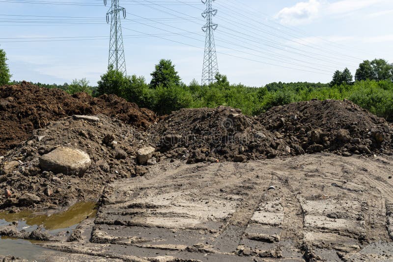 Digging Out Peat from Marshy Swamps, Visible Rubble and Stones Piled ...