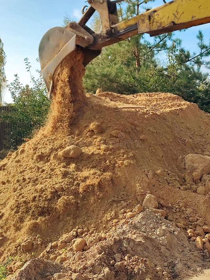 Digging the Pit Foundation a Hole with Excavator at the Construction ...