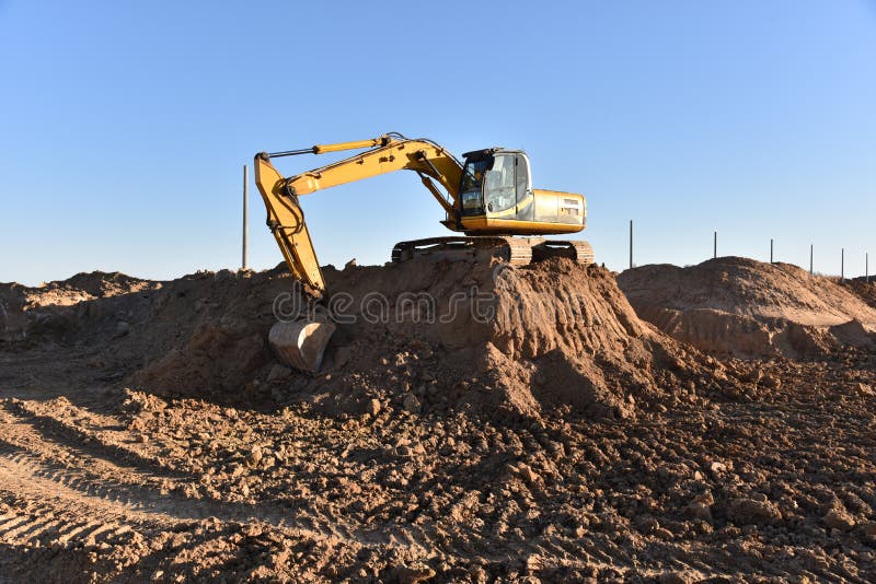 Digging the Pit Foundation a Hole with Excavator. Earthwork in ...