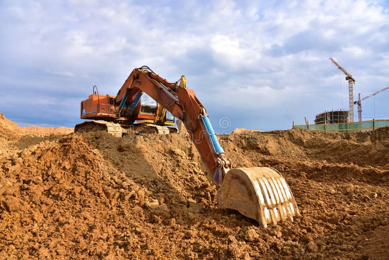 Digging the Pit Foundation a Hole with Excavator. Earthwork in ...
