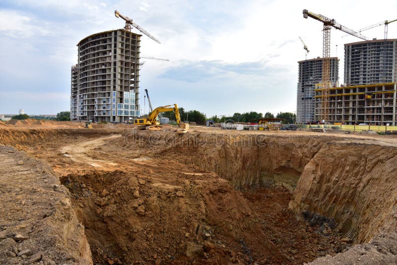 Digging the Pit Foundation a Hole with Excavator. Earthwork in ... Digging the Pit Foundation a Hole with Excavator. Earthwork in ...