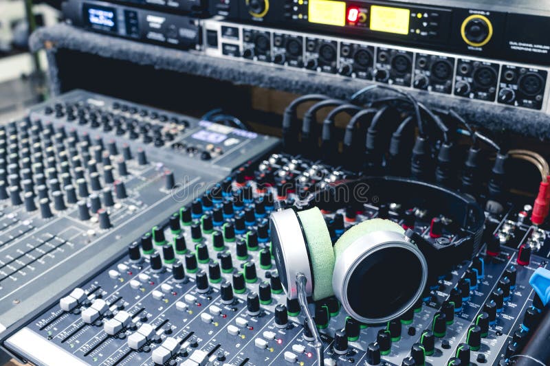 A Digital and Analog Mixer Placed Side by Side, with a Headset Placed ...
