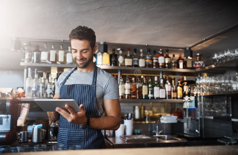 The Digital Bartender. a Young Man Using a Digital Tablet while Working ...