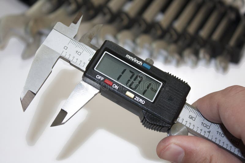 Digital Calliper in the Hand with Tools in the Background Stock Image ...
