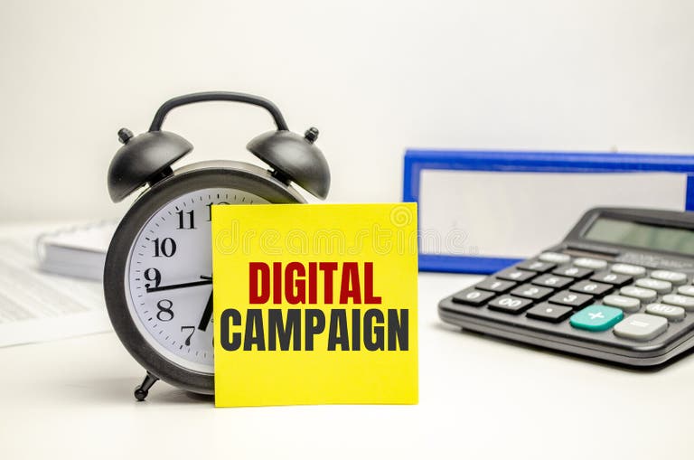 DIGITAL CAMPAIGN Text on Yellow Sticker with Clock and Blue Paper ...