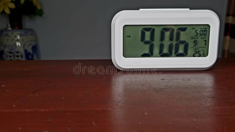 The Digital Clock on the Table Shows Nine Past Six Stock Photo - Image ...