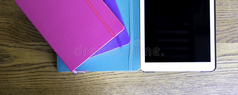 Digital Computer Tablet with a Collection of Multi Colored Notebooks ...