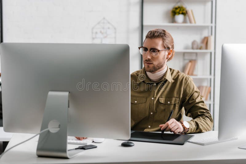 Digital Designer Using Computer and Graphics Tablet at Table Stock ...