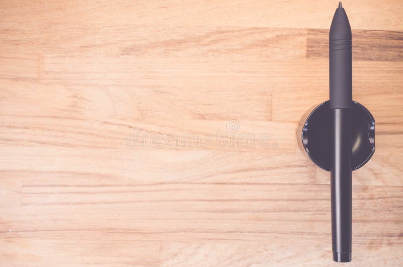 Digital Drawing Pen and Pen Holder on a Wooden Surface with Copy Space ...