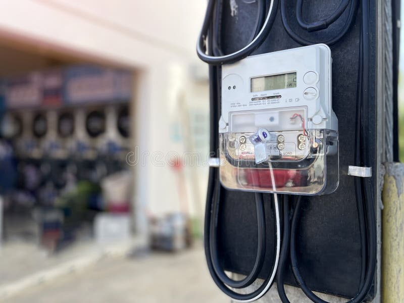 A Digital Electricity Meter on a Pole in Front of a Building Stock ...