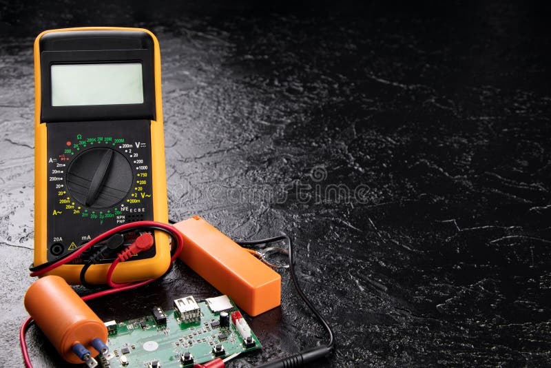 Digital Multi-meter with Probes on a Black Stone Background ...