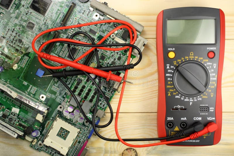 Digital Multimeter with Circuit Board on a Wooden Table Stock Image ...