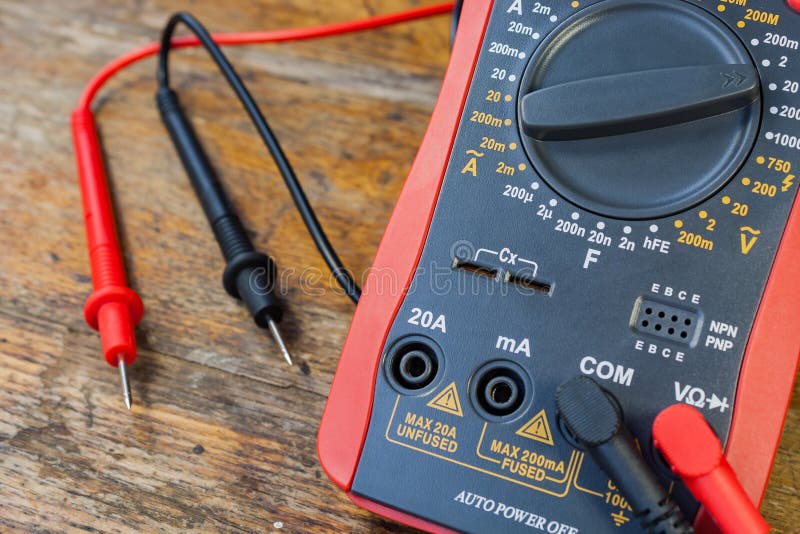 Digital Multimeter with the Connected Probes on a Table in a Workshop ...