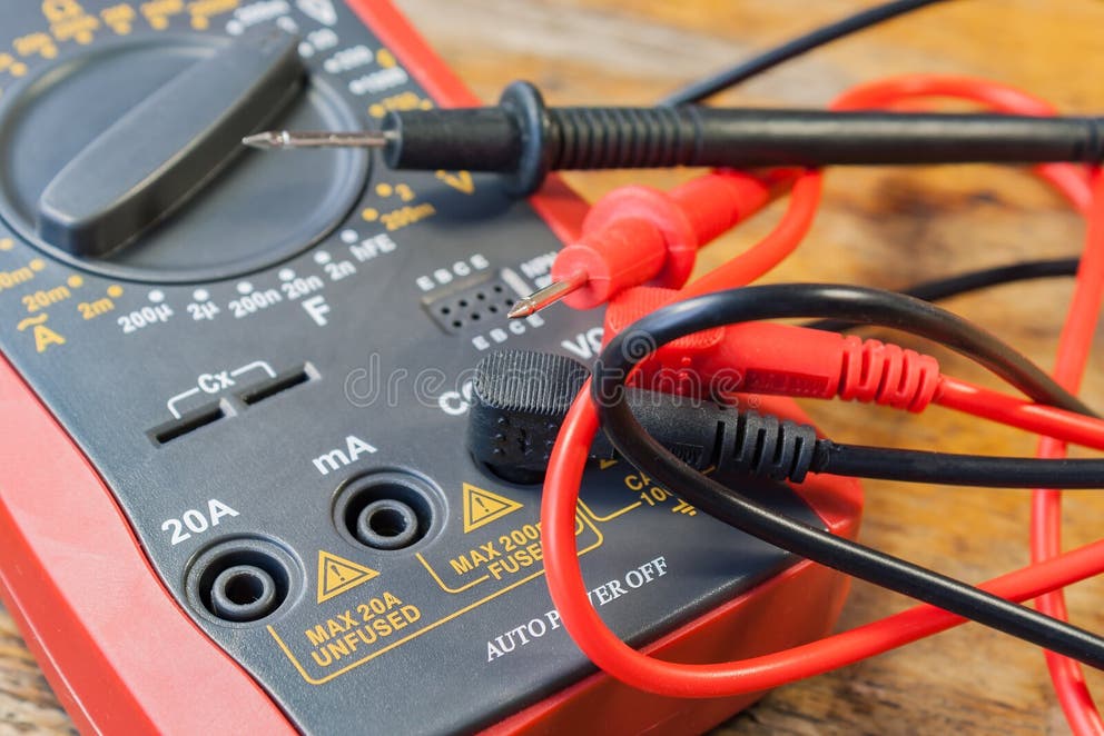 Digital Multimeter with the Connected Probes on a Table in a Workshop ...