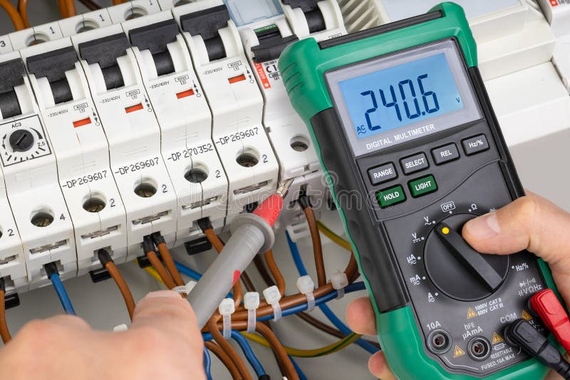 Electrician Testing Voltage in Circuit Breaker System with Multimeter ...