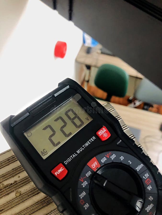 A Digital Multimeter Displays an AC Voltage Reading of 228 Volts during ...