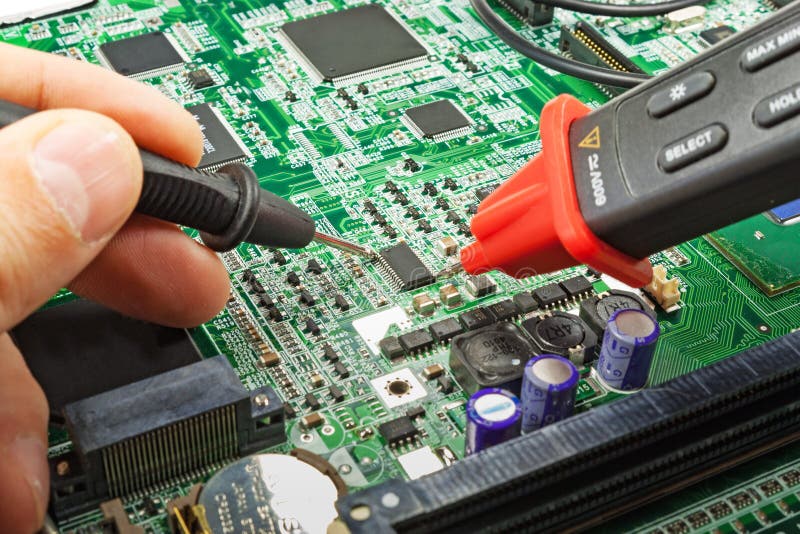 Digital Multimeter with Probe in the Master`s Hands in a Workshop Stock ...