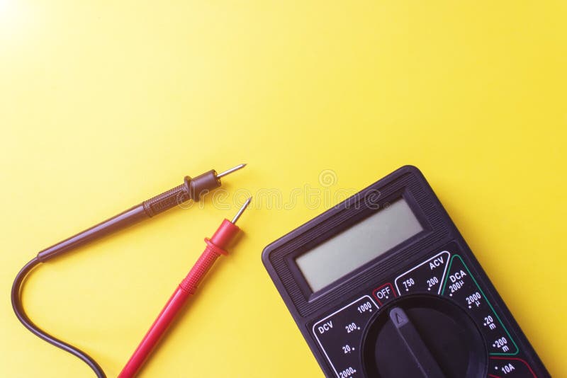 Digital Multimeter with Probes and Backlit Display on a Yellow ...