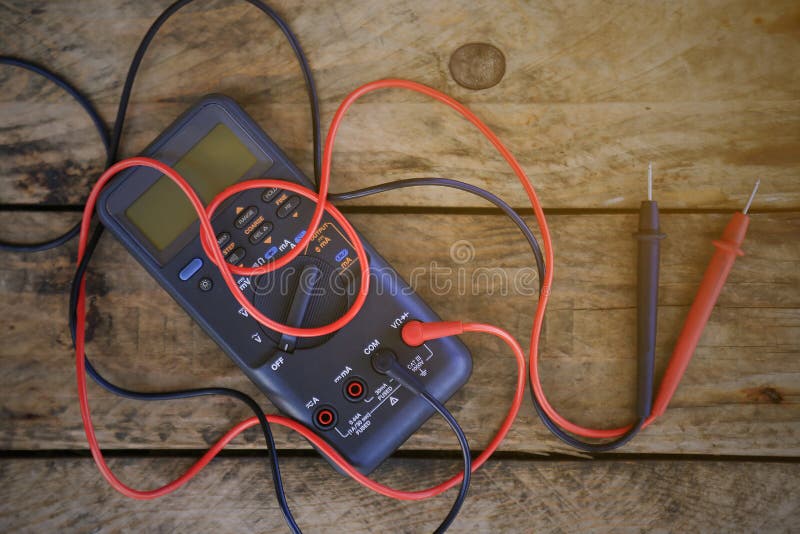 Digital Multimeter and Wiring on Wooden Table. Special Tools of ...
