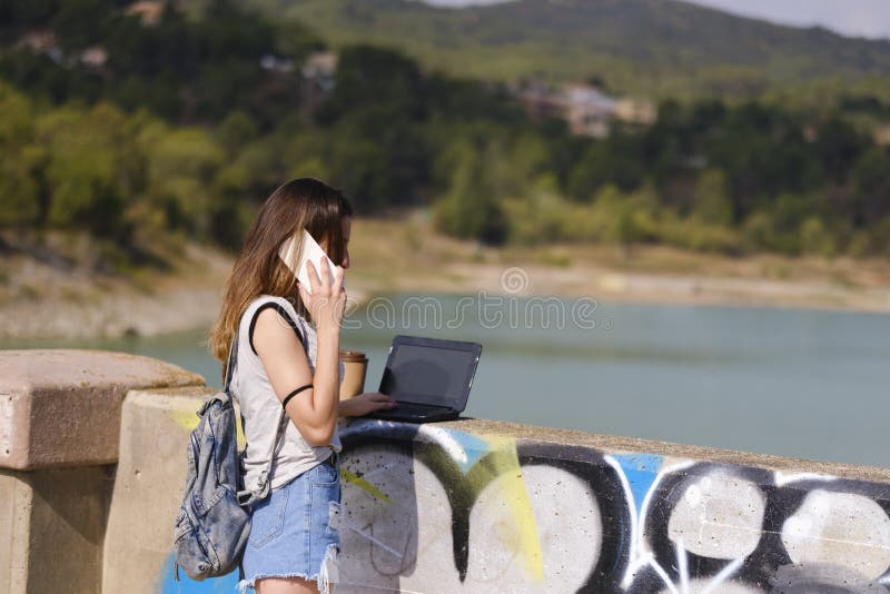 Digital Nomad. Girl Working with the Computer in a Natural Setting ...