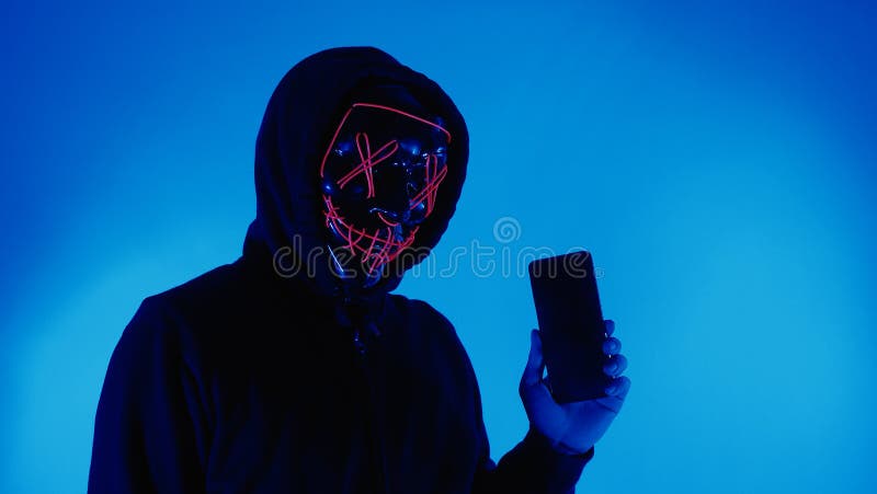 Digital Security Concept. Anonymous Hacker with Mask Holding Smartphone ...