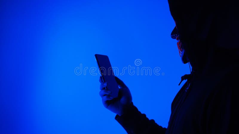 Digital Security Concept. Anonymous Hacker with Mask Holding Smartphone ...