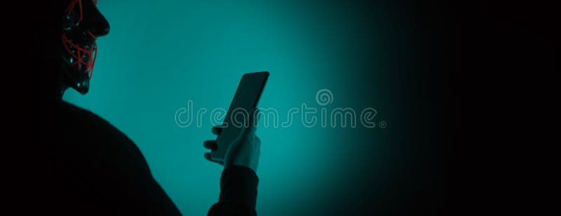 Digital Security Concept. Anonymous Hacker with Mask Holding Smartphone ...