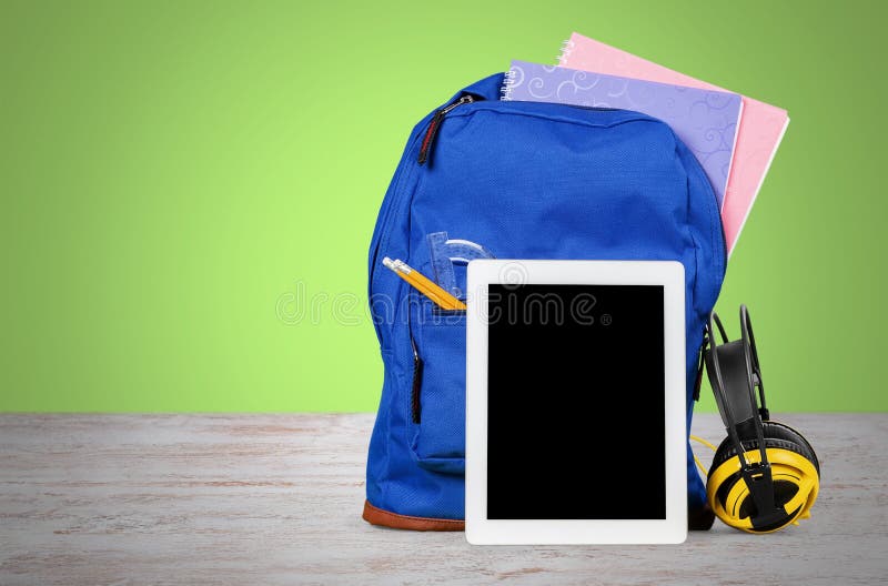 Digital Tablet and Backpack on the Table Stock Image - Image of ...