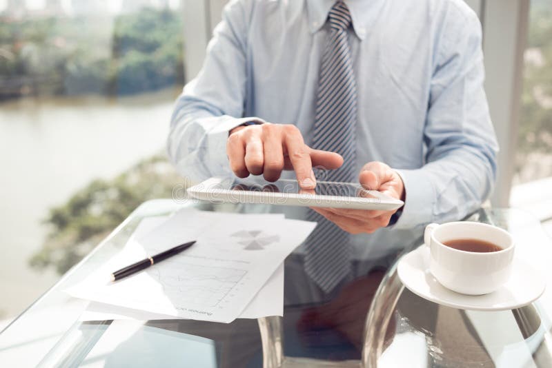 Businessman Using Digital Tablet with Charts for Planning and Analysis ...