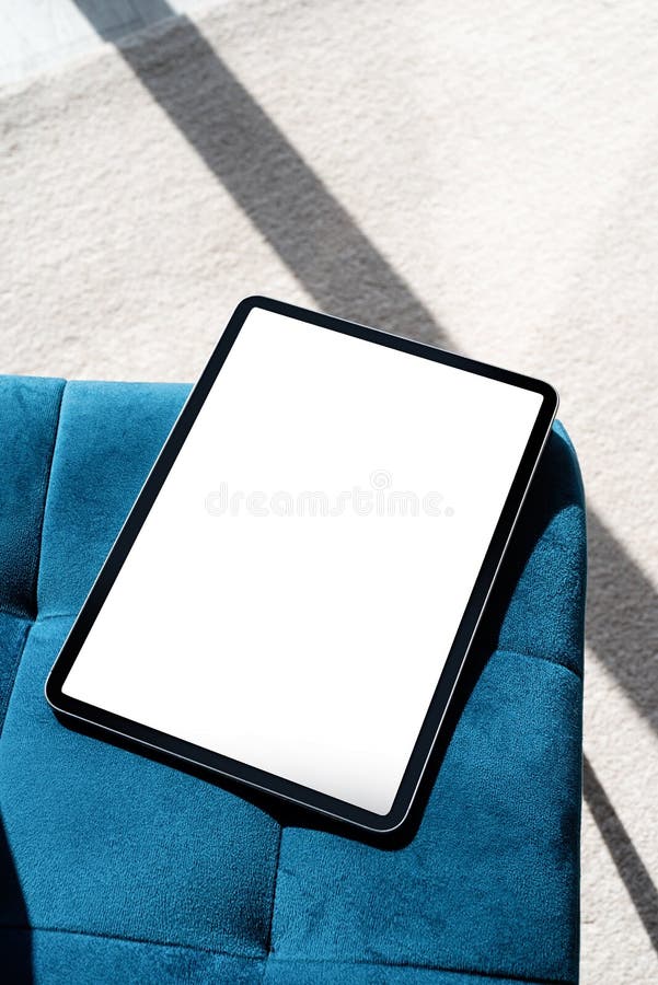 Digital Tablet Computer with Isolated Screen on Blue Chair. at Home ...