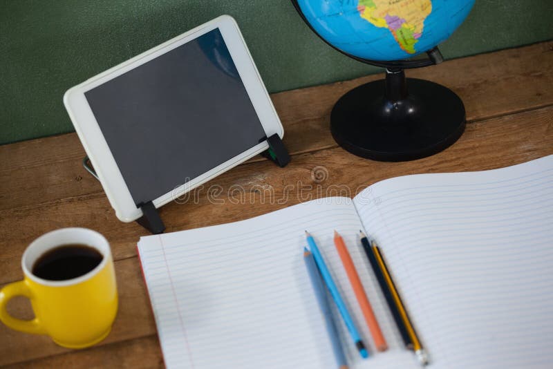 Digital Tablet and Globe on Table in Classroom Stock Photo - Image of ...