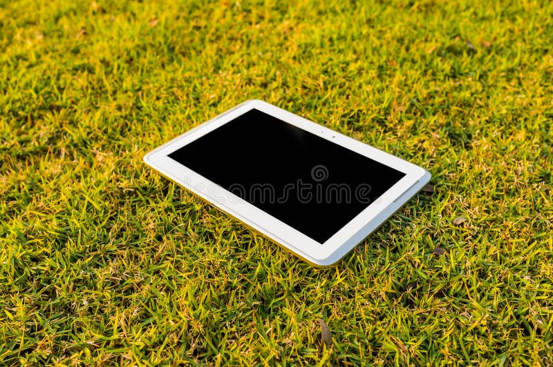 Digital Tablet in Grass Field Stock Image - Image of mobility ...