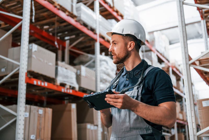 With Digital Tablet in Hands. Employee in Uniform is Working in the ...