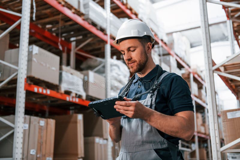 With Digital Tablet in Hands. Employee in Uniform is Working in the ...