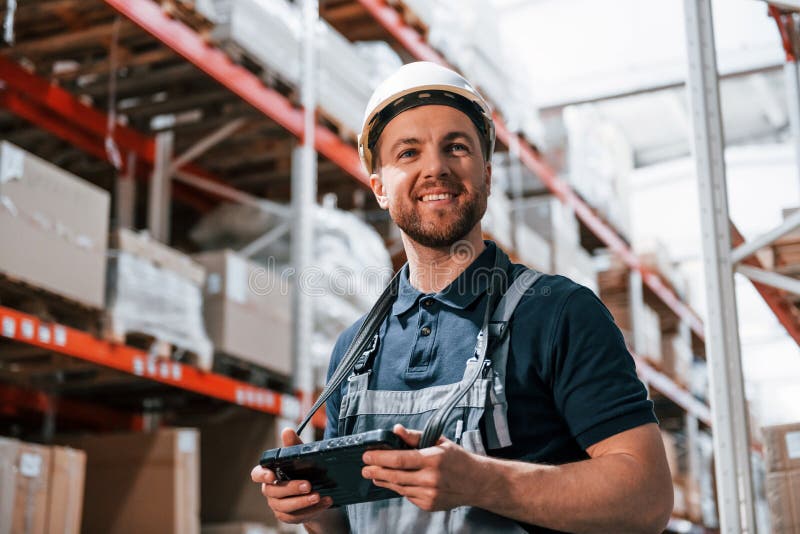 With Digital Tablet in Hands. Employee in Uniform is Working in the ...