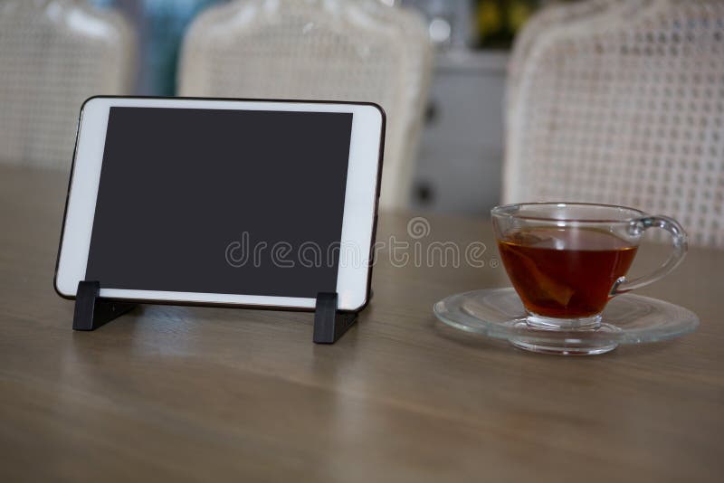 Digital Tablet and Lemon Tea on Dining Table Stock Photo - Image of ...