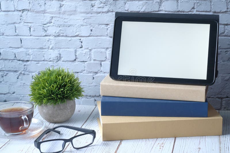 Digital Tablet and Stack of Book on Table Stock Photo - Image of ebook ...