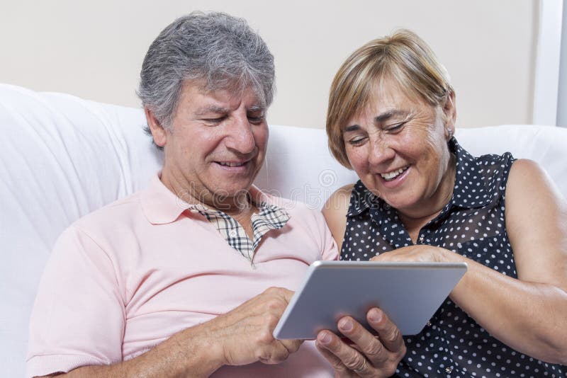 Digital Tablet Use by Couple of Senior People. Stock Photo - Image of ...