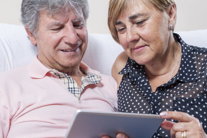 Digital Tablet Use by Couple of Senior People. Stock Image - Image of ...