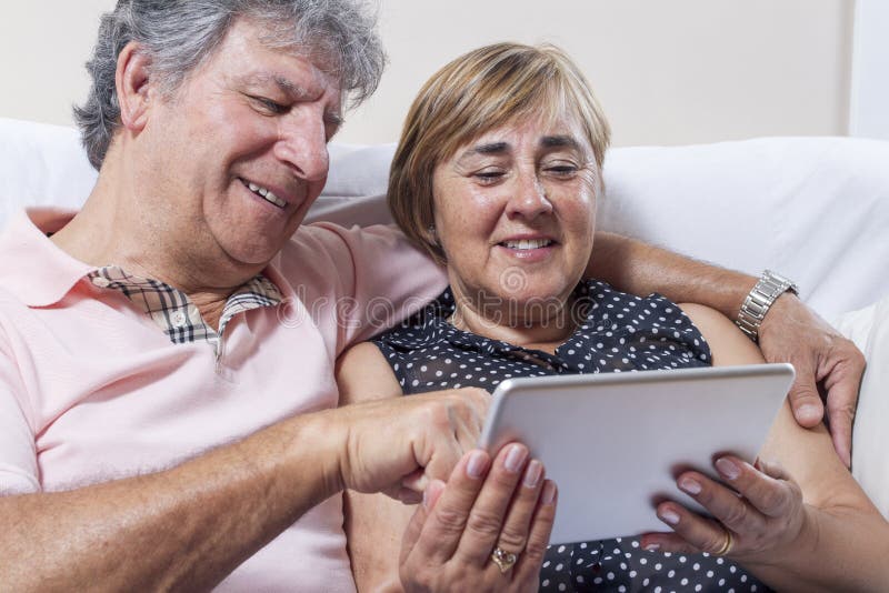 Digital Tablet Use by Couple of Senior People. Stock Photo - Image of ...