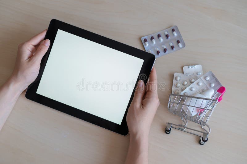 Digital Tablet with a White Screen in Female Hands and a Mini Cart with ...