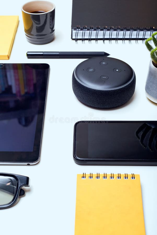 Digital and Wireless Technology Objects Arranged on a White Desk ...