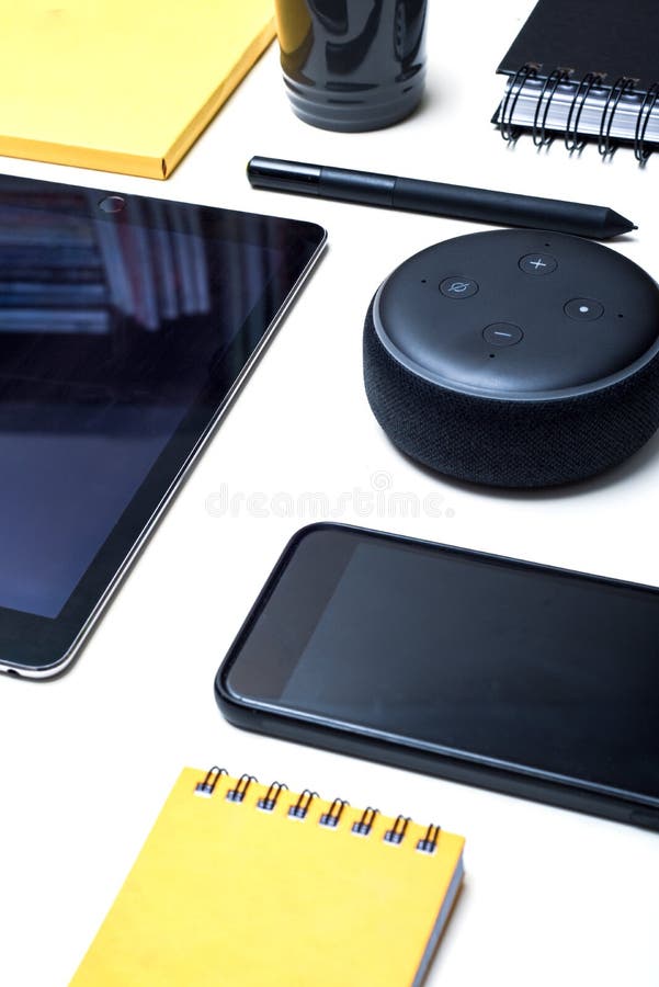 Digital and Wireless Technology Objects Arranged on a White Desk ...