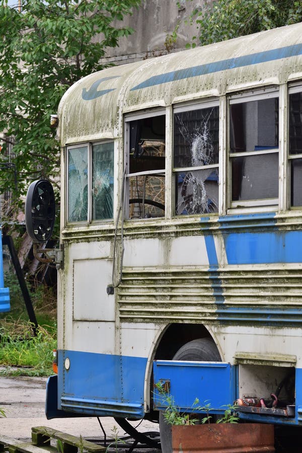 Dilapidated and Rusty Bus with Broken Windows in a Remote Area. Scrap ...