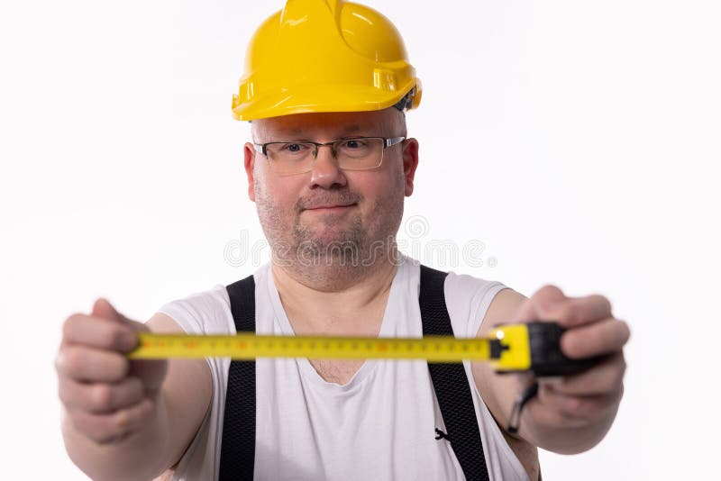 A Diligent Construction Worker is Measuring Something with a Tape ...