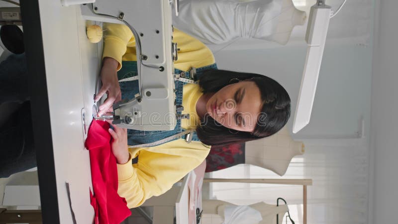 Diligent Tailor is Working in a Workshop, Sitting at a Sewing Machine ...