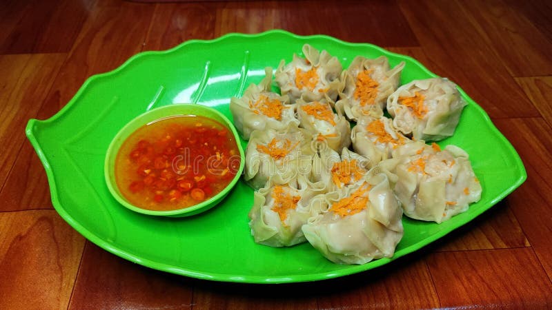 The Dim Sum with Chilli Sauce Ready To Serve on a Green Plate Stock ...